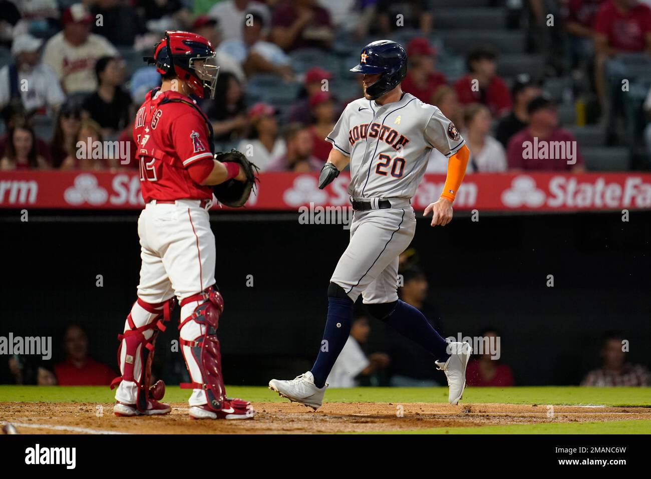 Houston Astros' Chas McCormick (20) scores off of a double hit by Jeremy Pena during the third ...