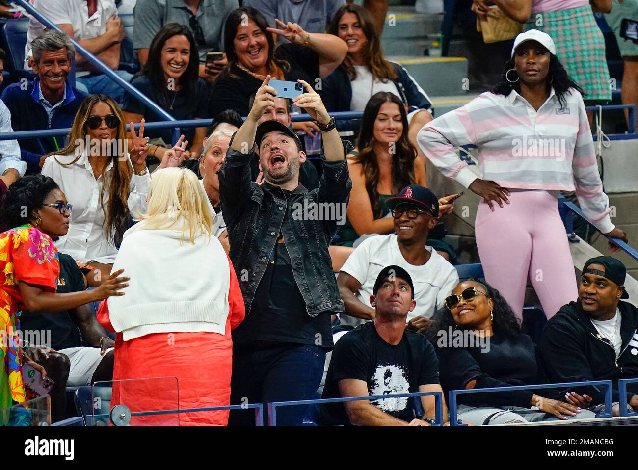 Alexis Ojanian, center, takes a selfie with guests in Serena Williams ...