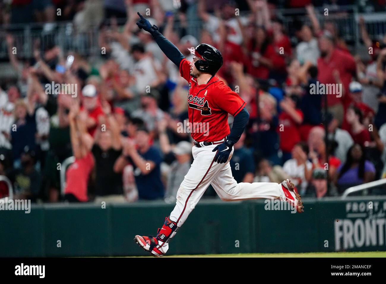 Atlanta Braves catcher Travis d'Arnaud gestures as he runs the bases ...