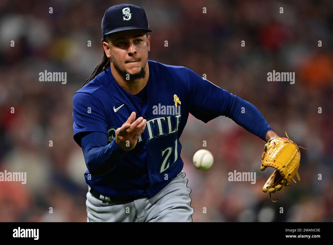 Seattle Mariners starting pitcher Luis Castillo flips the ball to first ...
