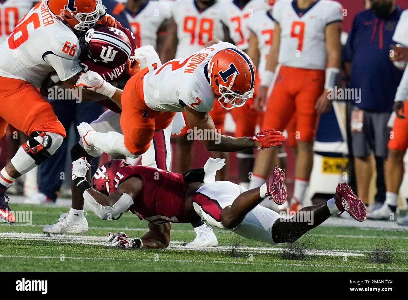 Illinois's Chase Brown (2) is tackled by Indiana's Bryant Fitzgerald ...