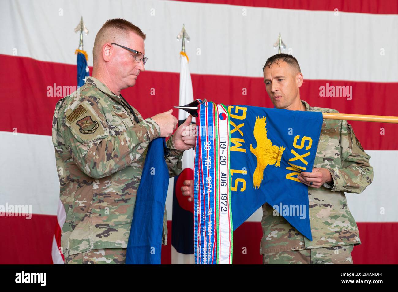 Col. Brian D. Moore, 51st Maintenance Group commander, left, assists Lt ...