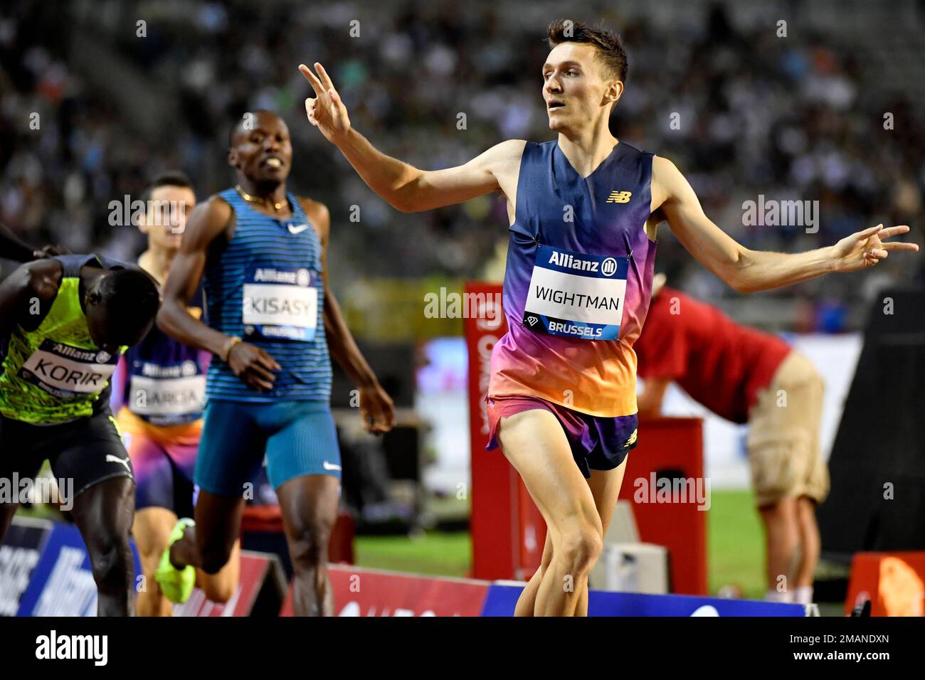 Britain's Jake Wightman, right, crosses the finish line to win the men ...