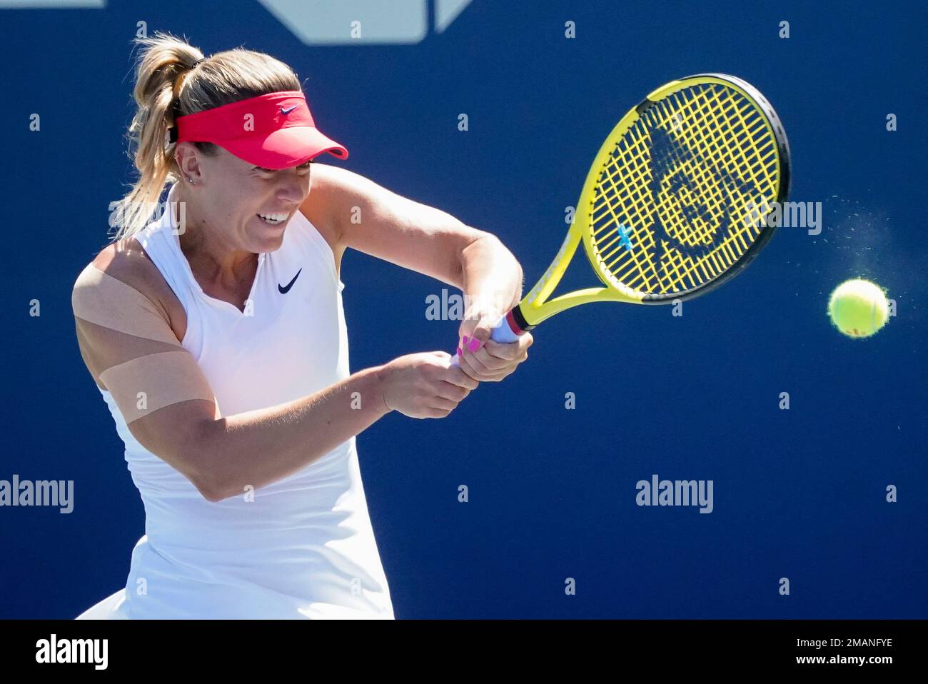 Dalma Galfi, of Hungary, returns a shot to Veronika Kudmermetova ...