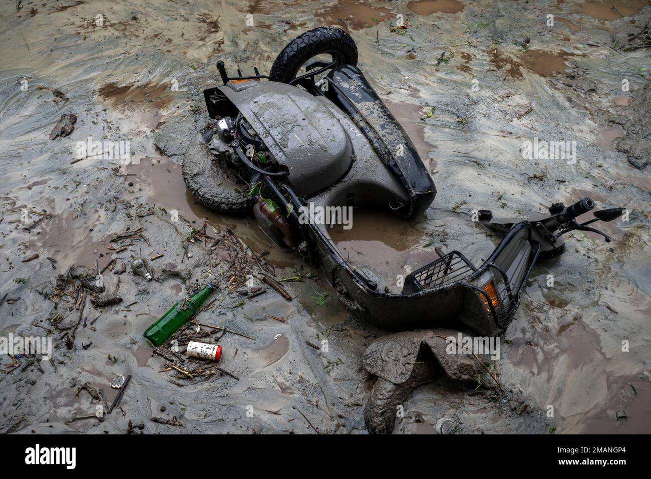 A scooter lies in slush after a landslide caused by heavy rainfall in ...