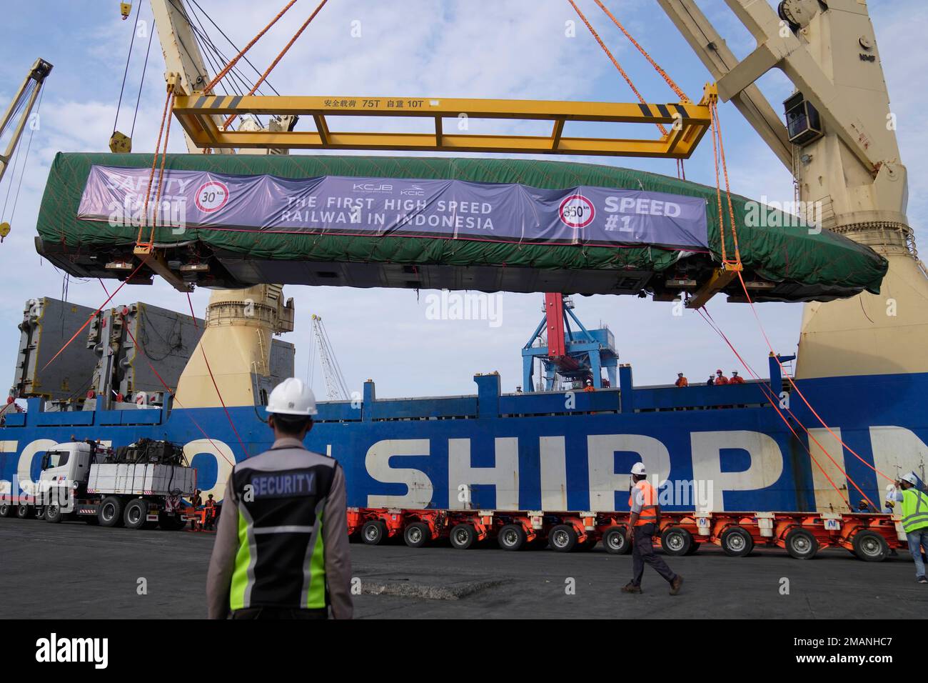 Workers unload a part of Chinese-made high-speed passenger train from a ...