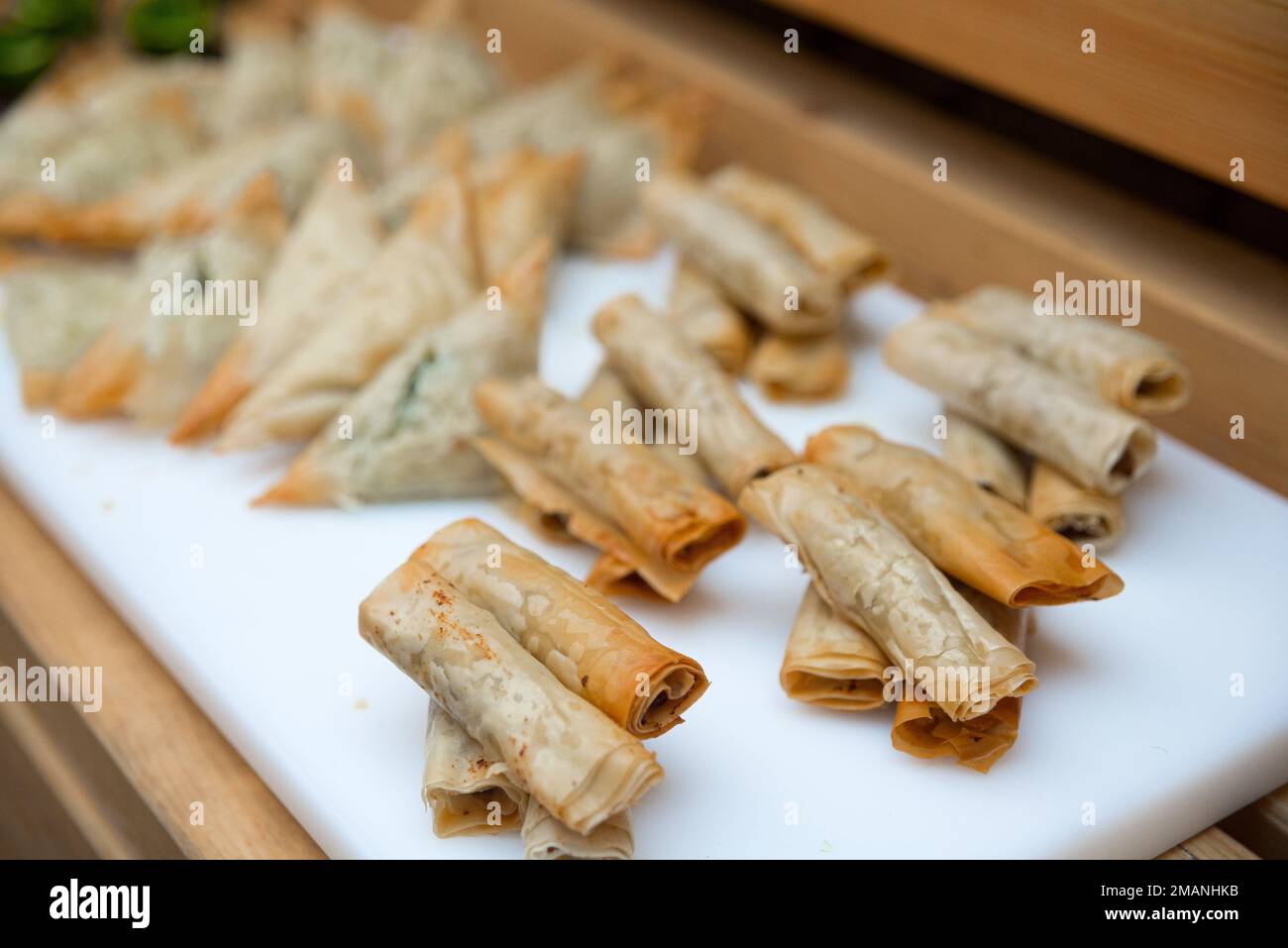 Filo puff pastry rolls with toppings fried in oil, assortment of ...