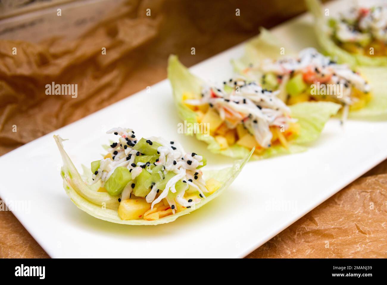 Breadless snacks on iceberg lettuce leaves cucumber slices and diced ...