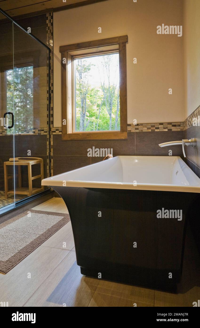 Master bedroom en suite with freestanding black and white bathtub and ...