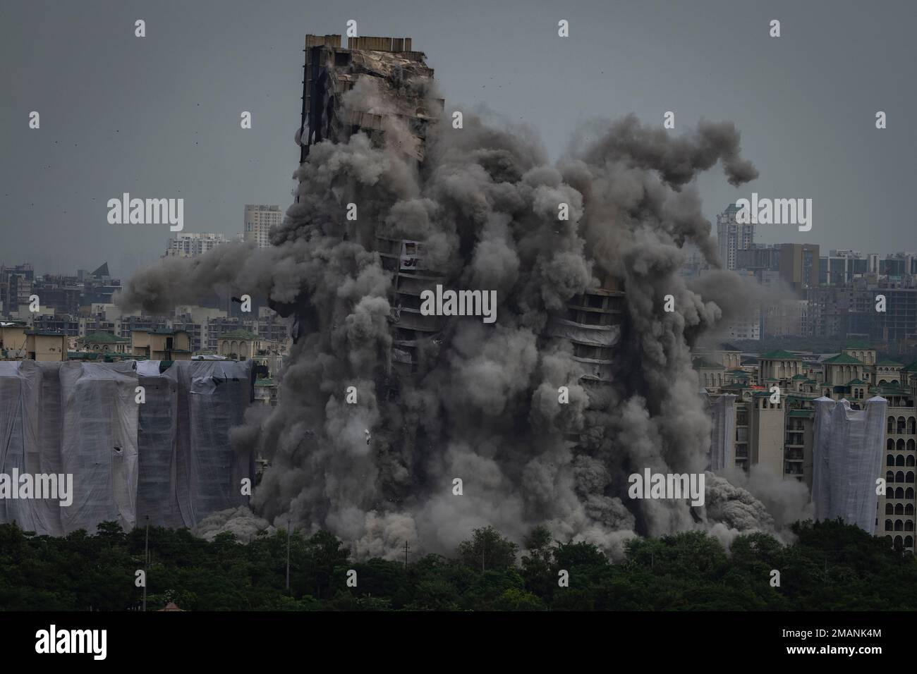 Cloud of dust rises as twin high-rise apartment towers are razed to ...