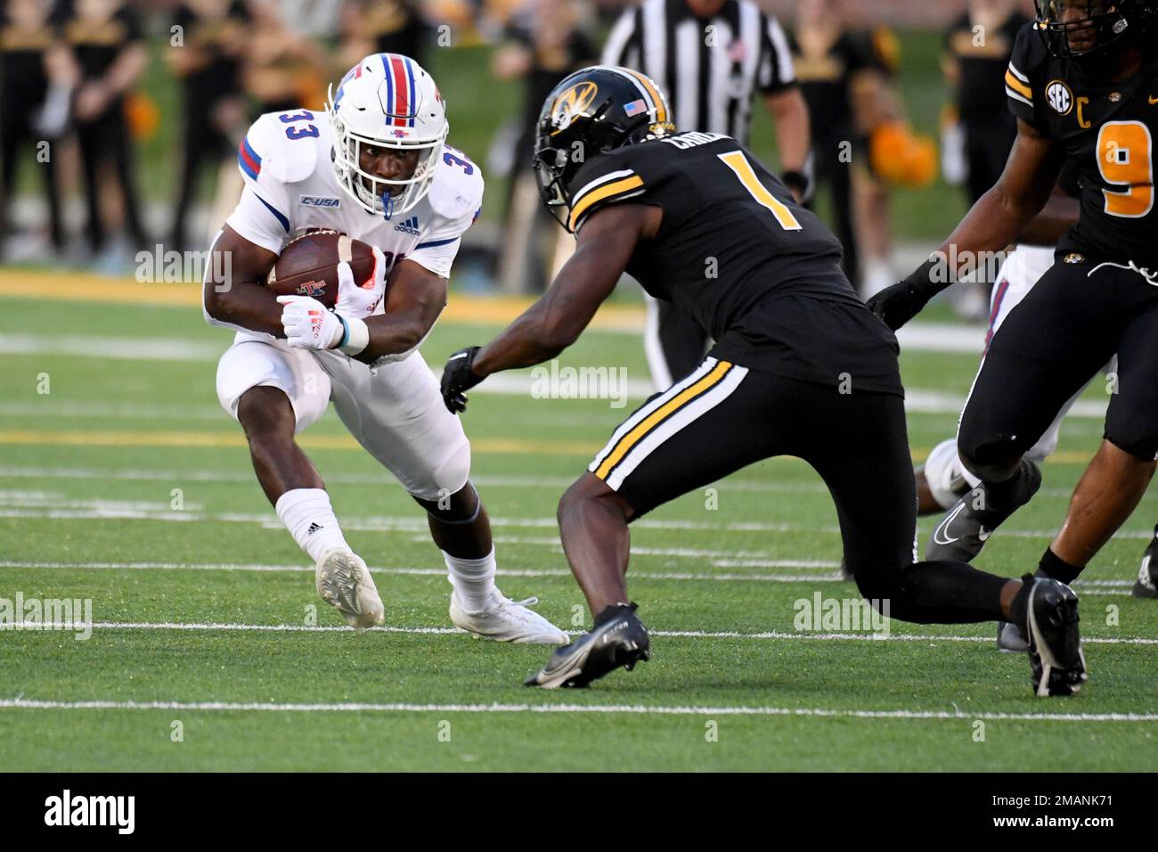 Louisiana Tech wide receiver Tre Harris runs with the ball as Missouri defensive back Jaylon ...