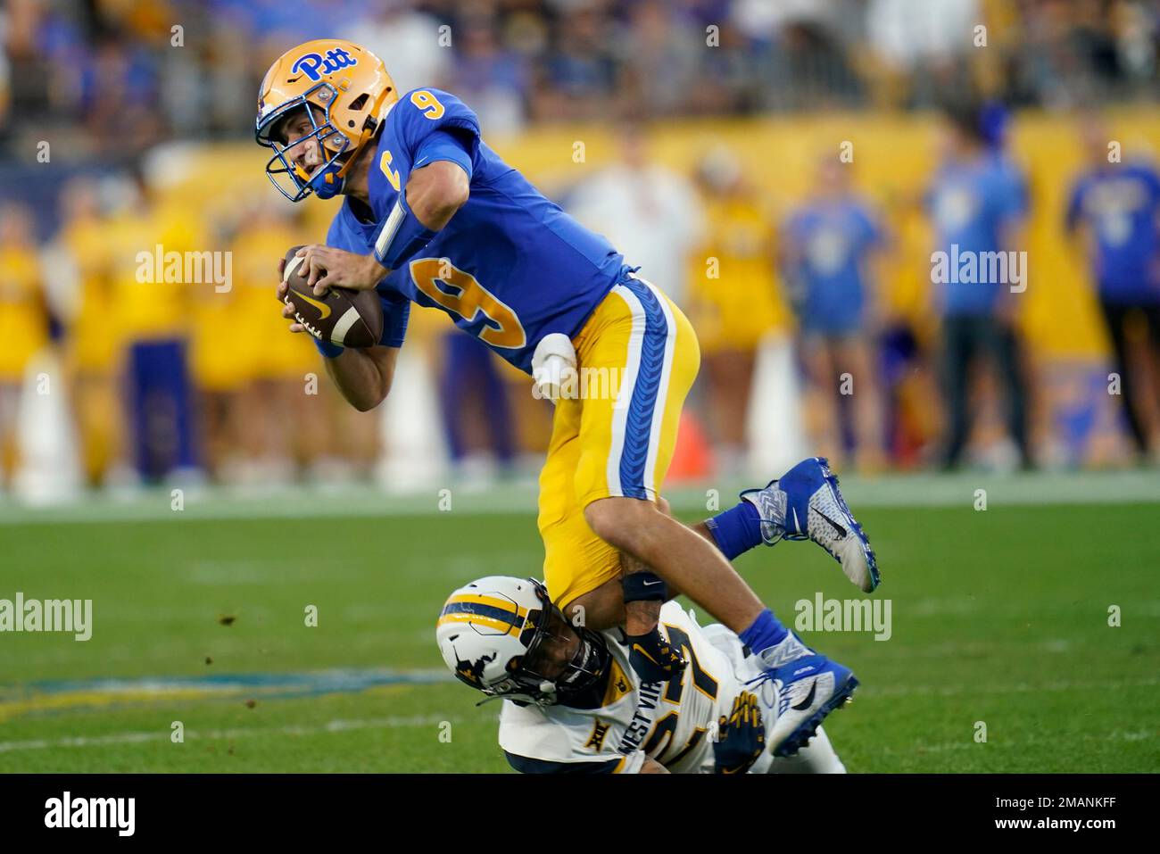 West Virginia safety Davis Mallinger (27) trips Pittsburgh quarterback ...