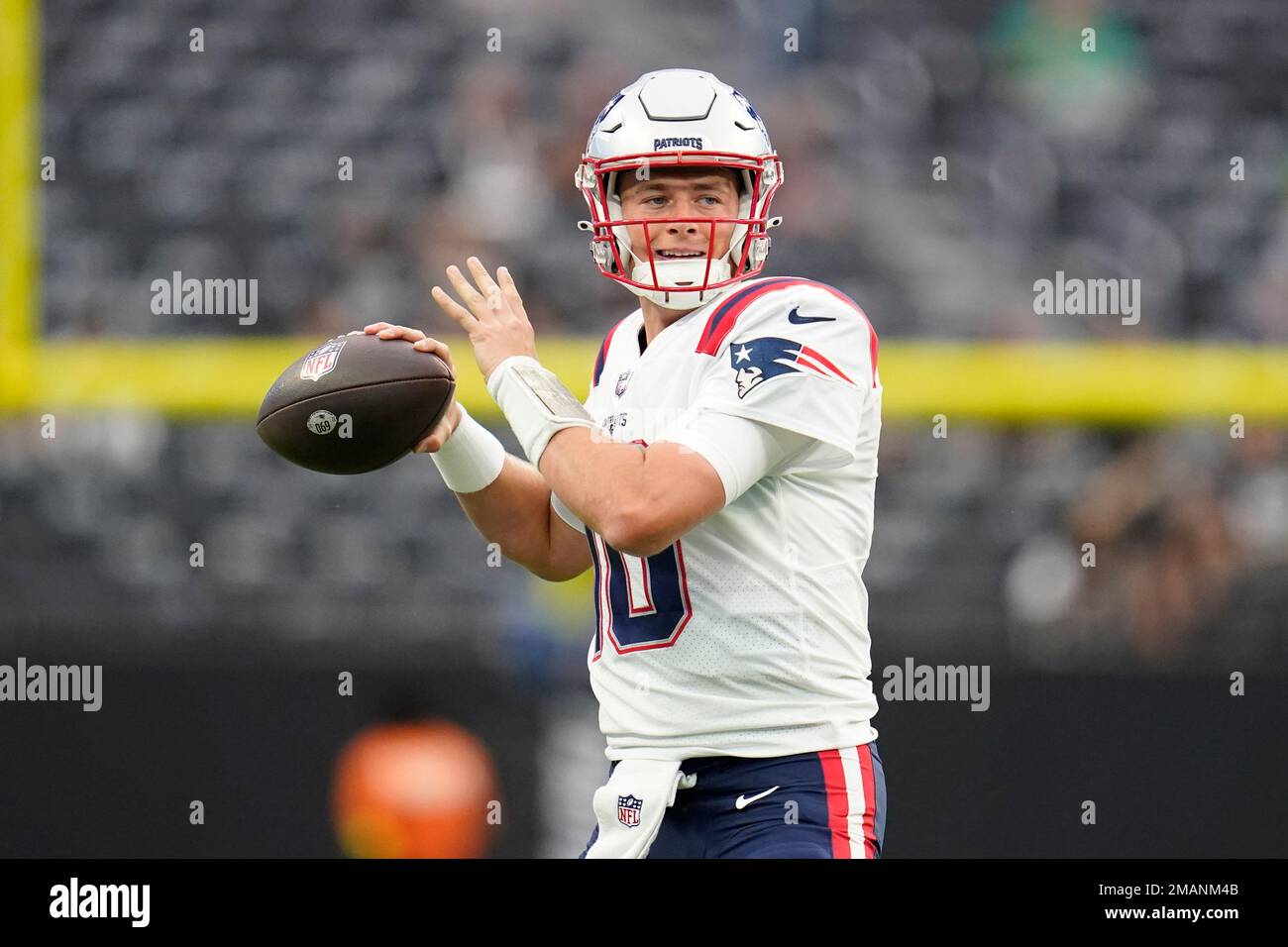 New England Patriots quarterback Mac Jones (10) warms up before an NFL ...