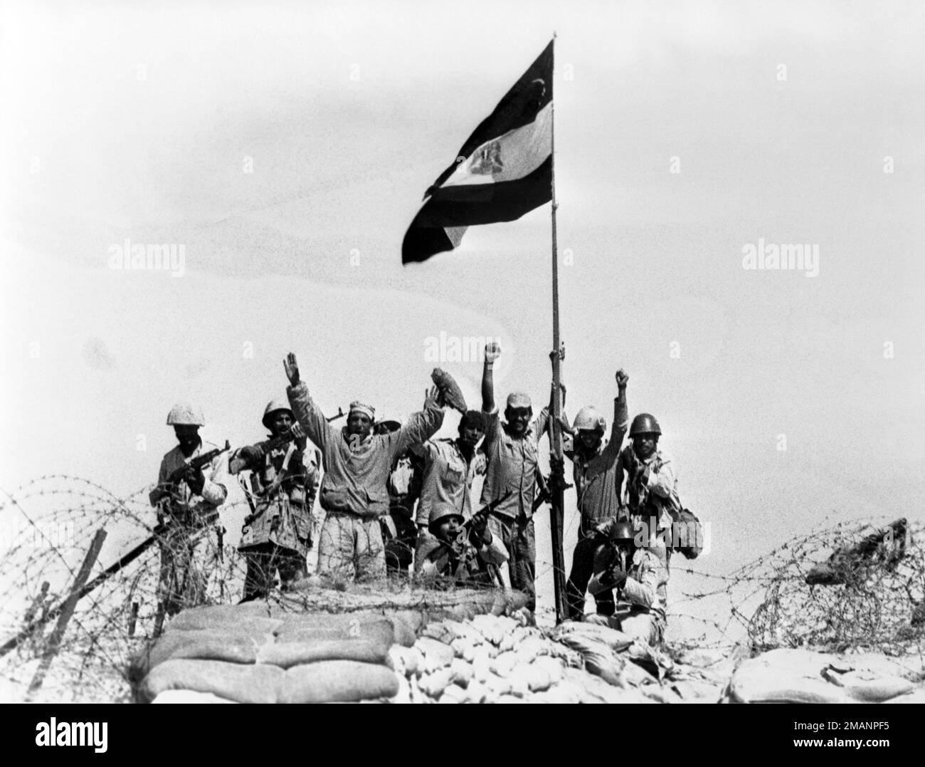 Egyptian troops pose atop a bunker on which they just planted their ...