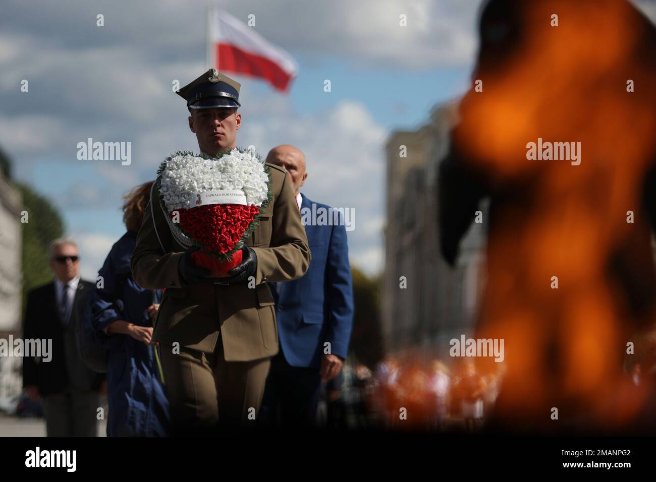 A Polish soldier holds a wreath while attending a ceremony marking ...