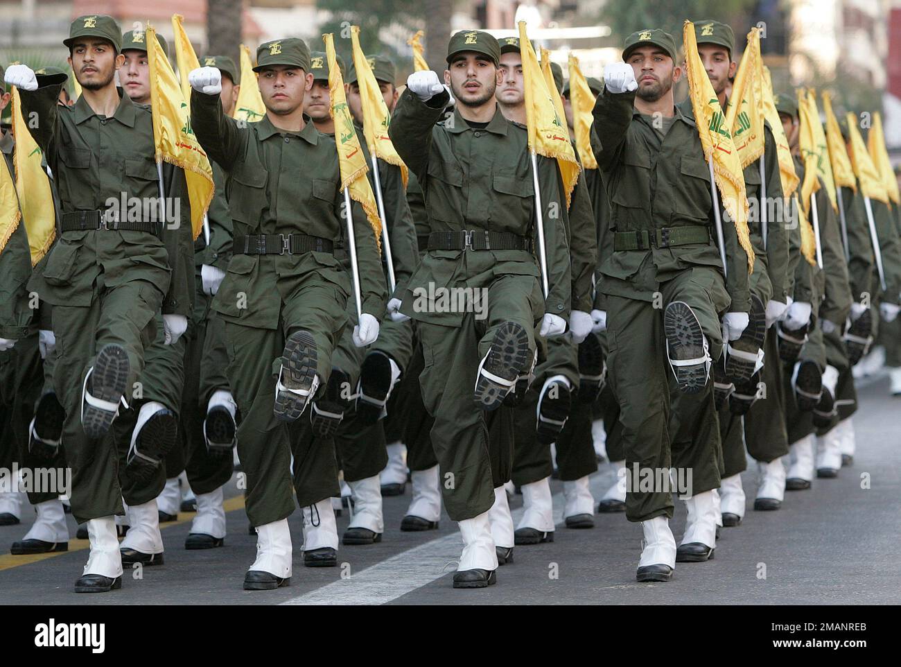 FILE - Members of the Hezbollah guerrilla group carry Hezbollah flags ...