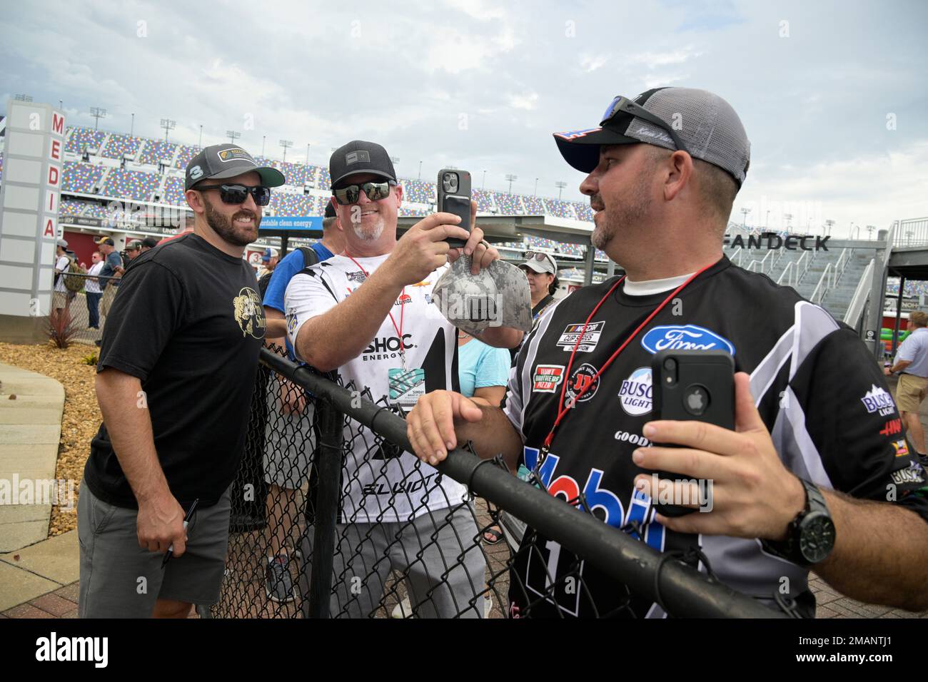 Austin Dillon, left, poses with fans before a NASCAR Cup Series auto ...