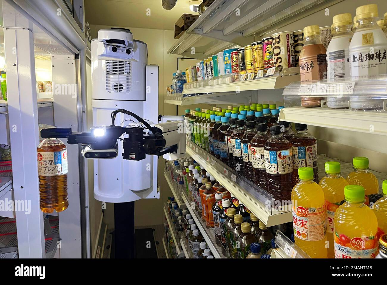 TX SCARA robot works, stocking drinks in the refrigerated section of a FamilyMart convenience ...