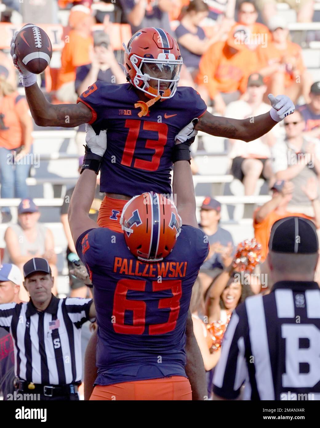 Illinois offensive lineman Alex Palczewski lifts wide receiver Pat ...