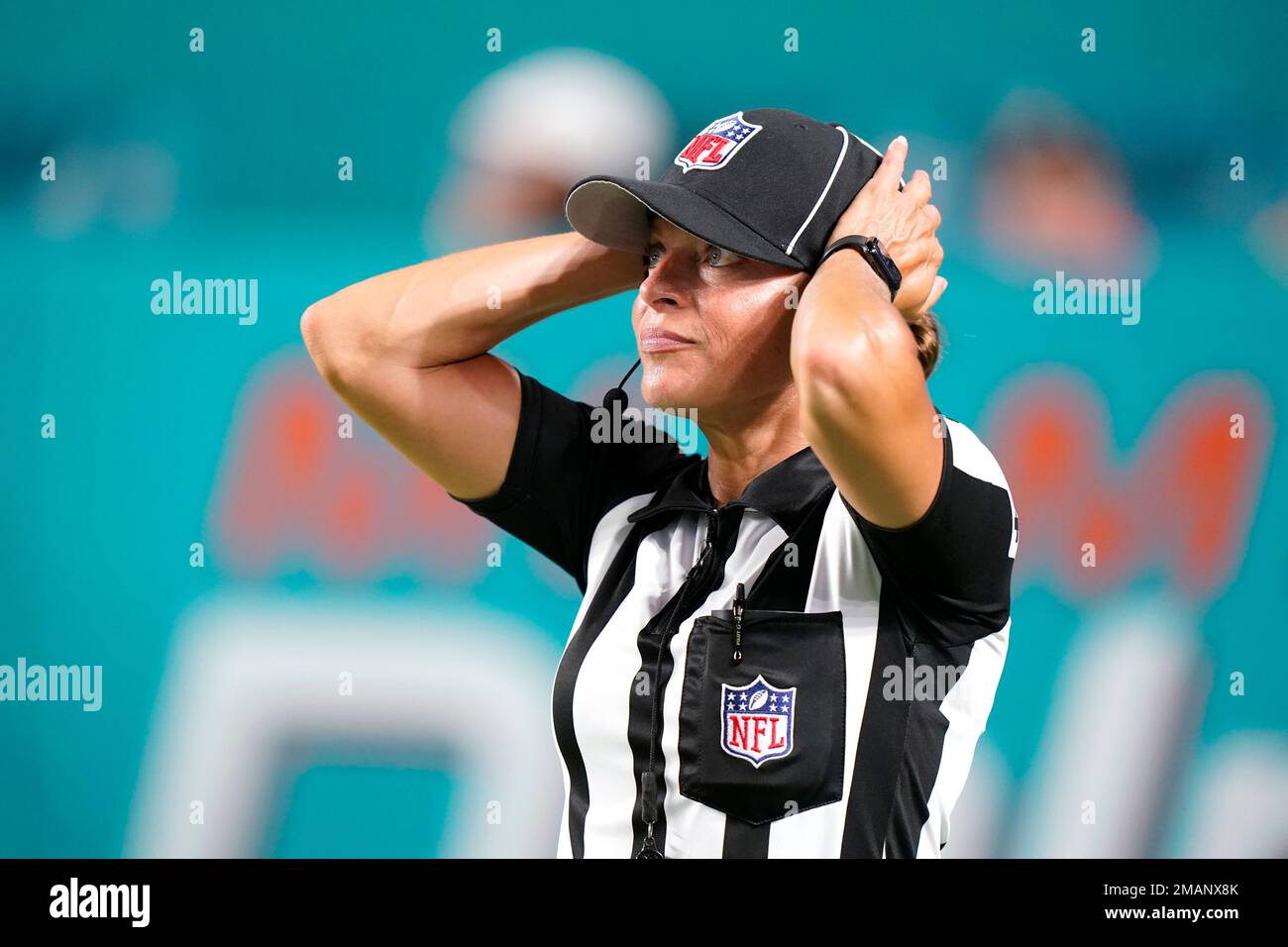NFL down judge Robin DeLorenzo adjusts her cap during the second half ...