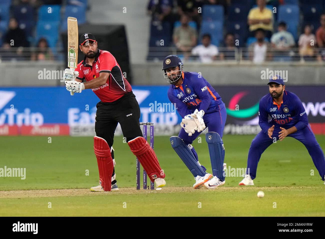 Hong Kong's Babar Hayat, left, plays a shot while India's wicketkeeper Rishabh Pant, center, and ...