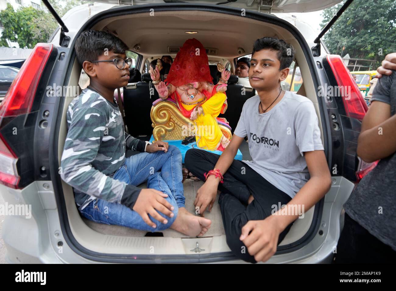 Devotees carries an idol of elephant-headed Hindu God Ganesha on a ...