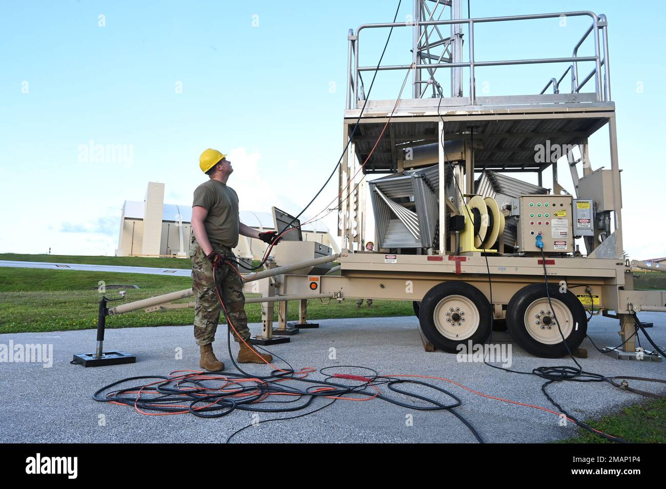 A U.S. Air Force member of the 119th Wing assists in raising the ...