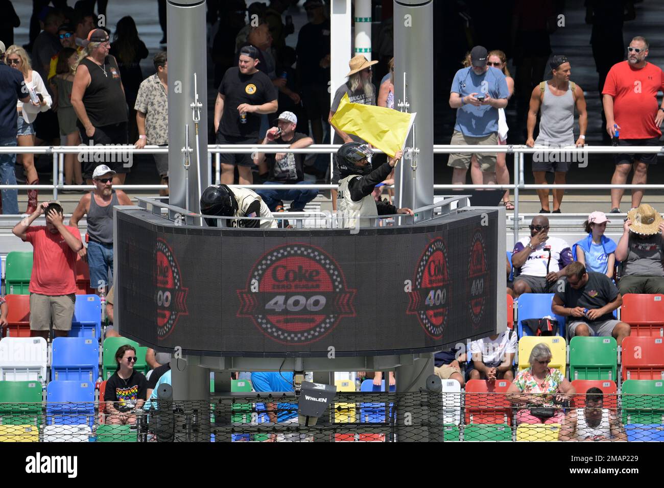 A track official waves a yellow caution flag during a NASCAR Cup Series ...