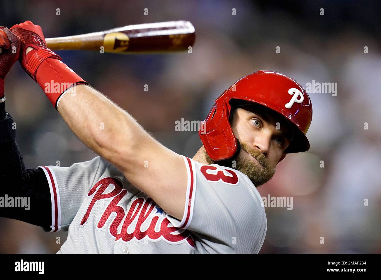 Philadelphia Phillies' Bryce Harper takes a practice swing as he waits his turn to bat against ...
