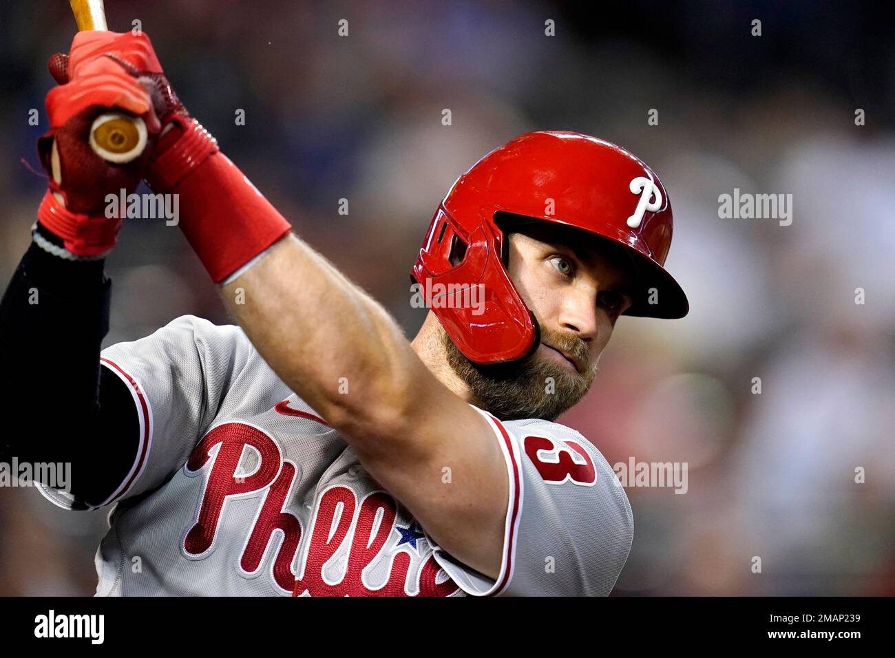 Philadelphia Phillies' Bryce Harper takes a practice swing as he waits his turn to bat against ...