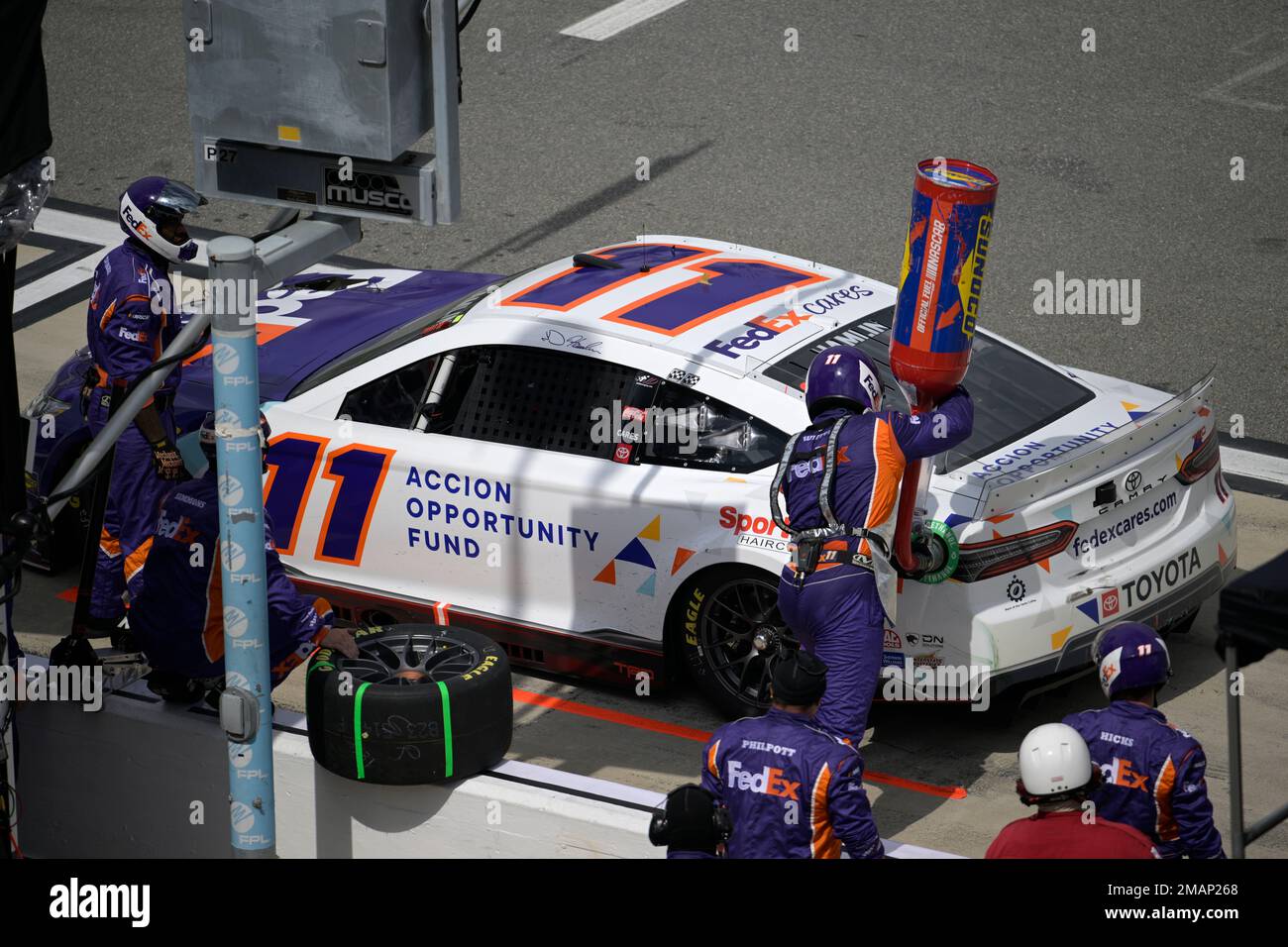 Denny Hamlin (11) makes a pit stop on pit road during a NASCAR Cup ...