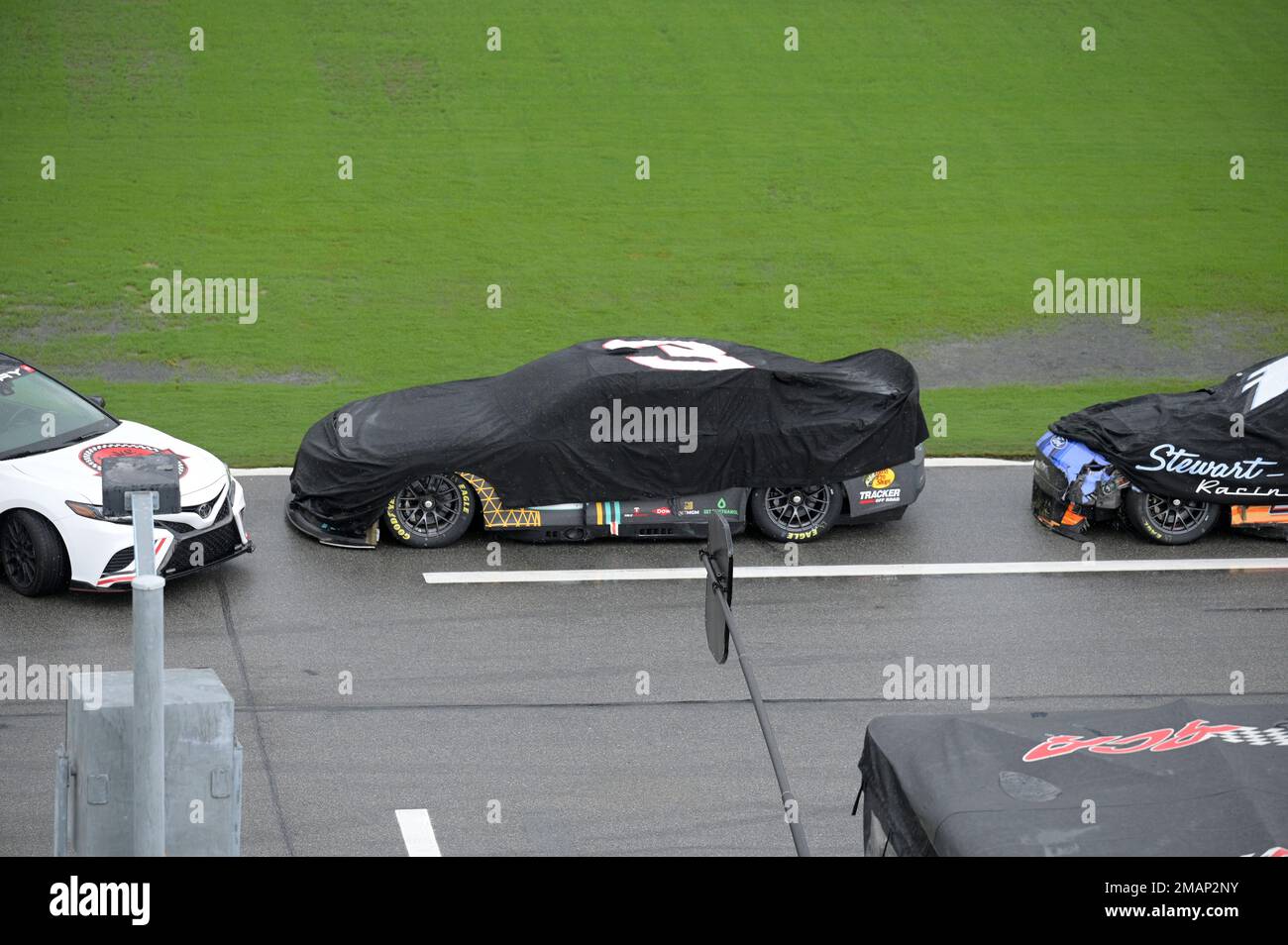 A tarp covers the car driven by Austin Dillon (3) on pit road during a ...