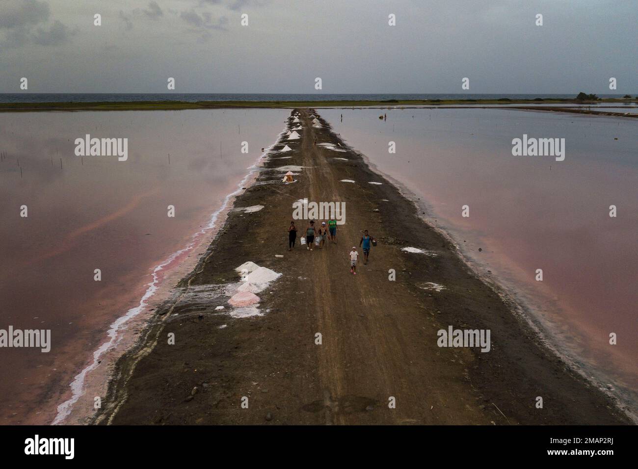 Salt collectors return to their homes after a day's work in the salt ...