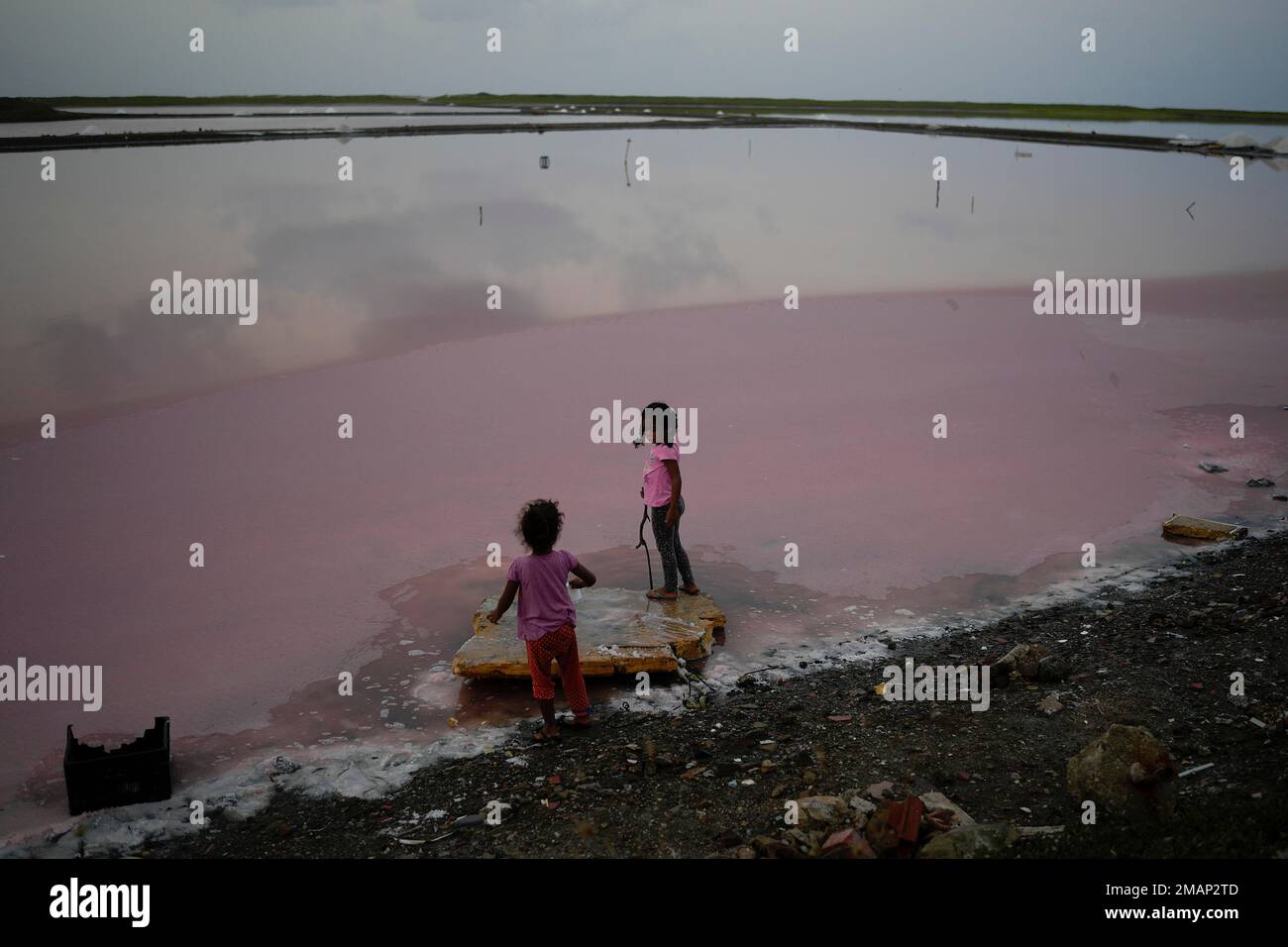 Children play near the salt flat of Pampatar on Margarita Island ...