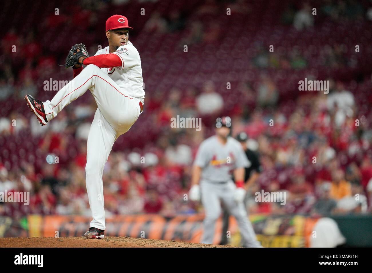 Cincinnati Reds relief pitcher Alexis Diaz, left, prepares to throw ...