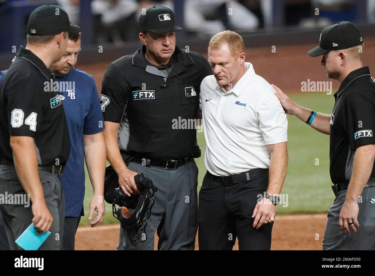 MLB home plate umpire Jim Reynolds is assisted off the field after he was hit by a pitch in the ...