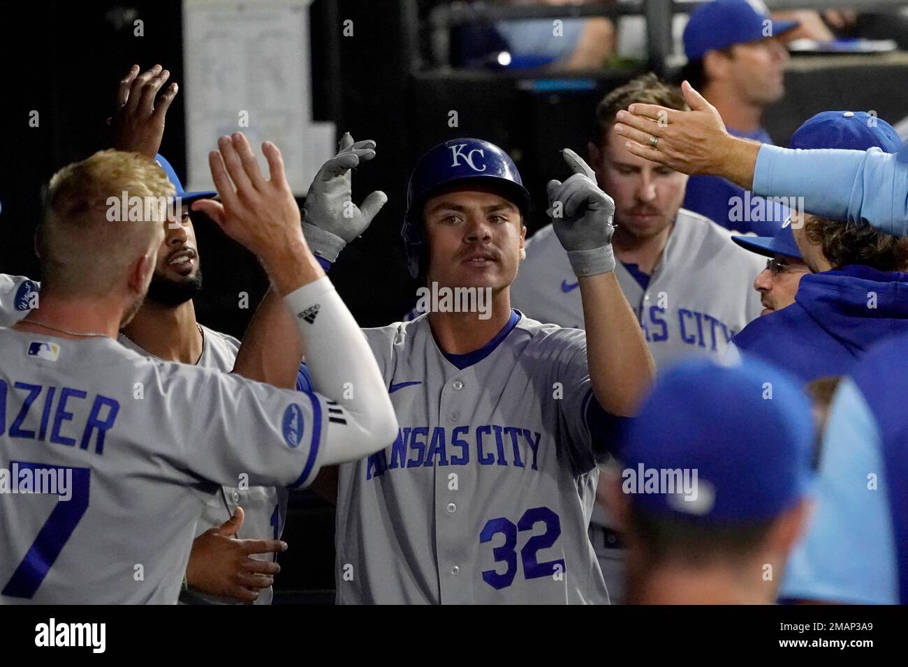 Kansas City Royals' Nick Pratto is congratulated in the dugout after ...