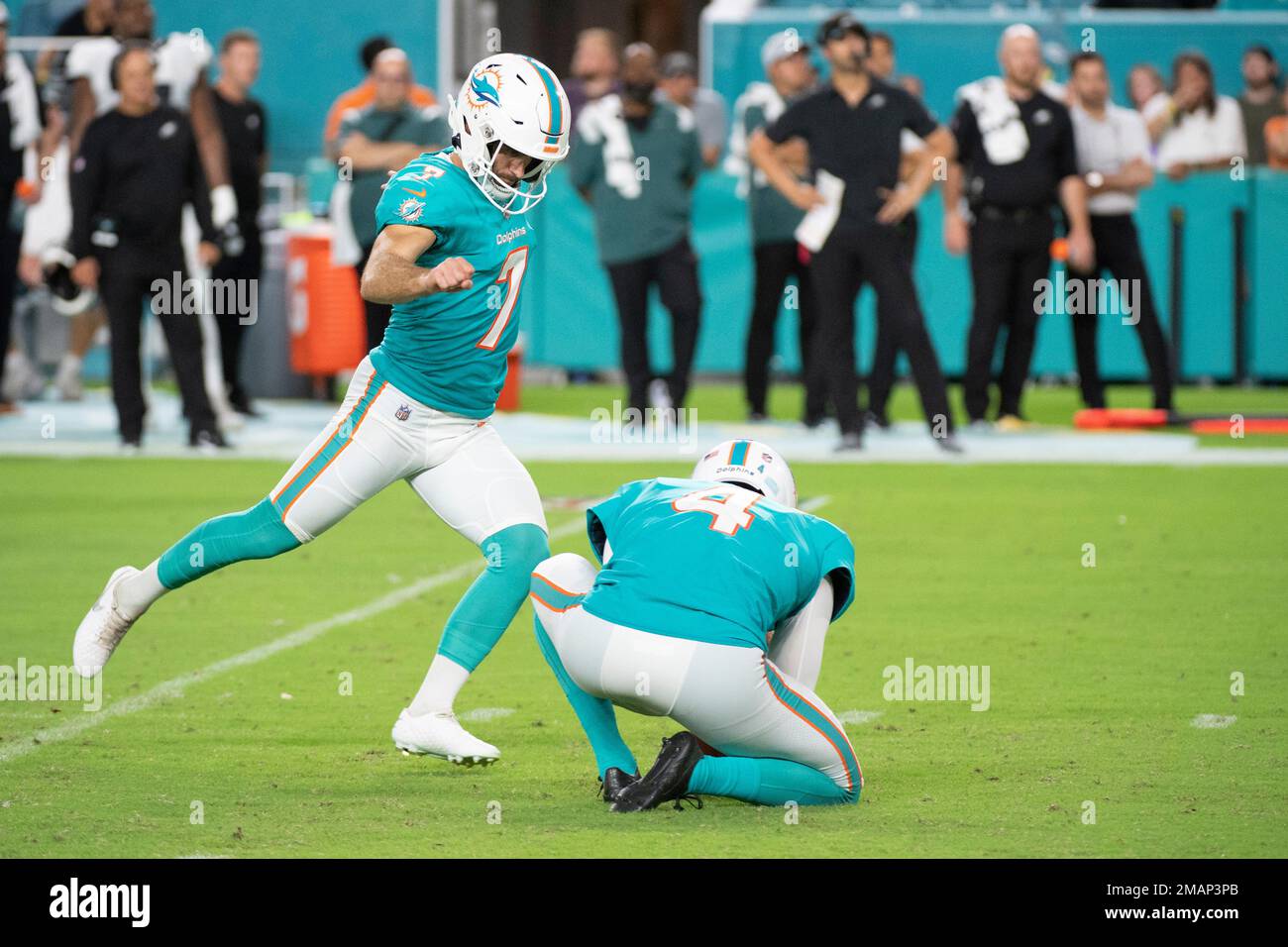 Miami Dolphins punter Thomas Morstead (4) holds the ball as Miami Dolphins kicker Jason Sanders ...