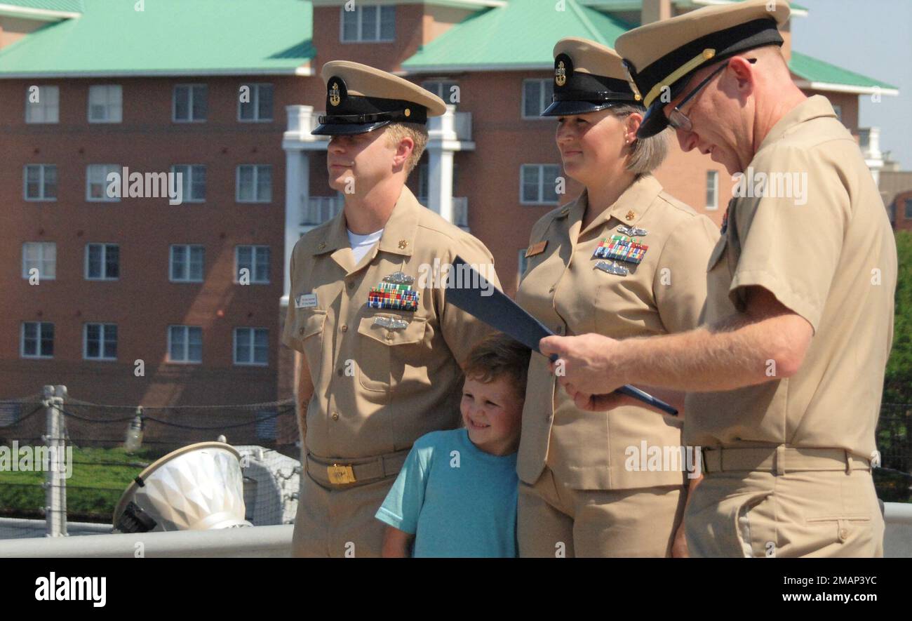 Colton Eisenmenger (center) stands between his parents, ETC(SW/AW/IW ...