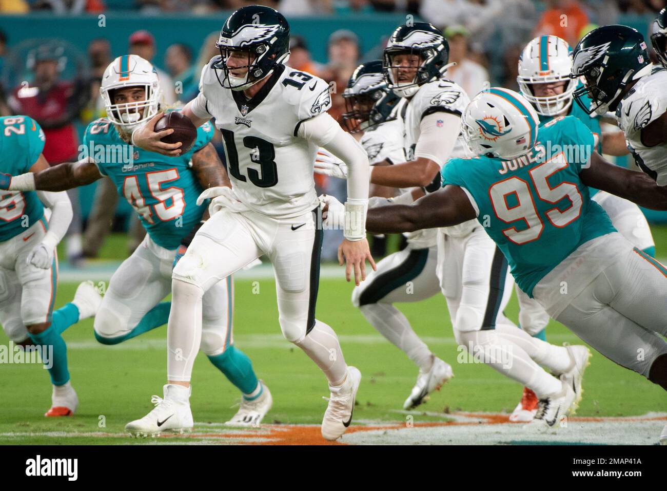 Philadelphia Eagles quarterback Reid Sinnett (13) runs with the ball past Miami Dolphins ...