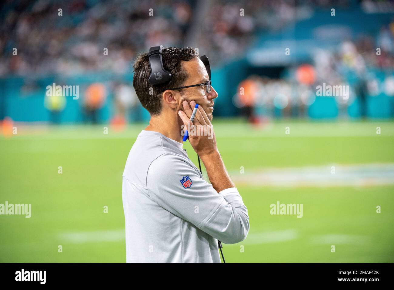 Miami Dolphins head coach Mike McDaniel holds his face as he watches ...
