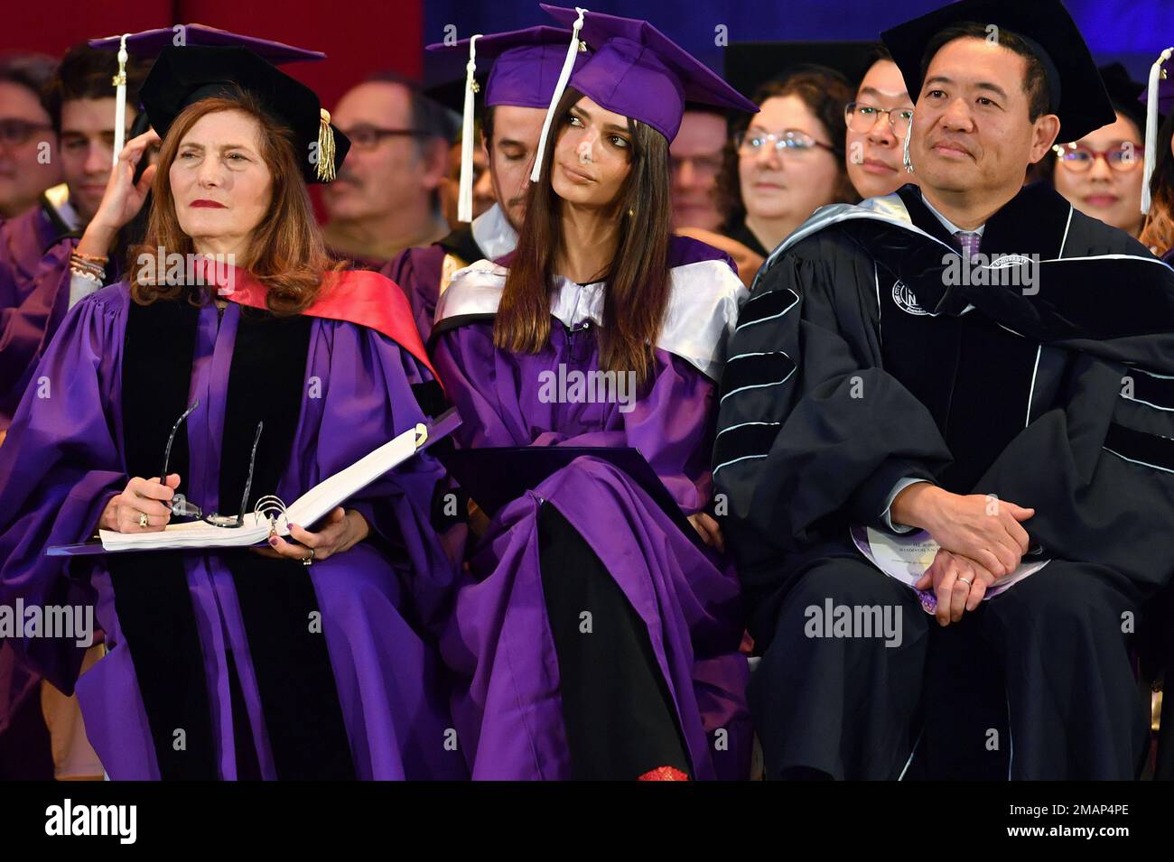 Model and author Emily Ratajkowski (c) waits to deliver the ...