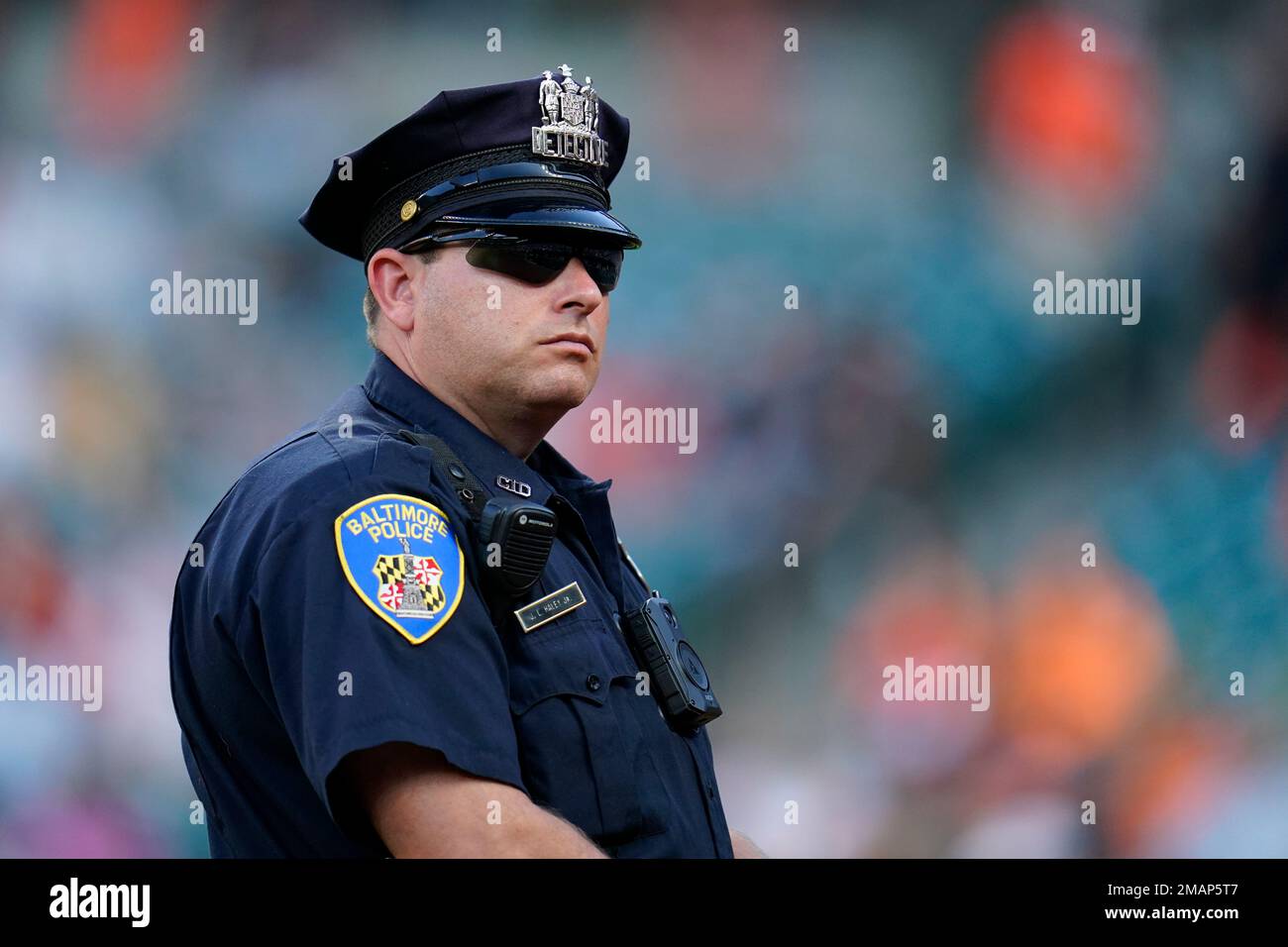 A Baltimore Police Department detective stands on the warning track ...