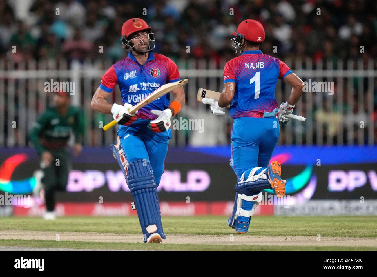 Afghanistan's Ibrahim Zadran, left, and Najibullah Zadran run between ...