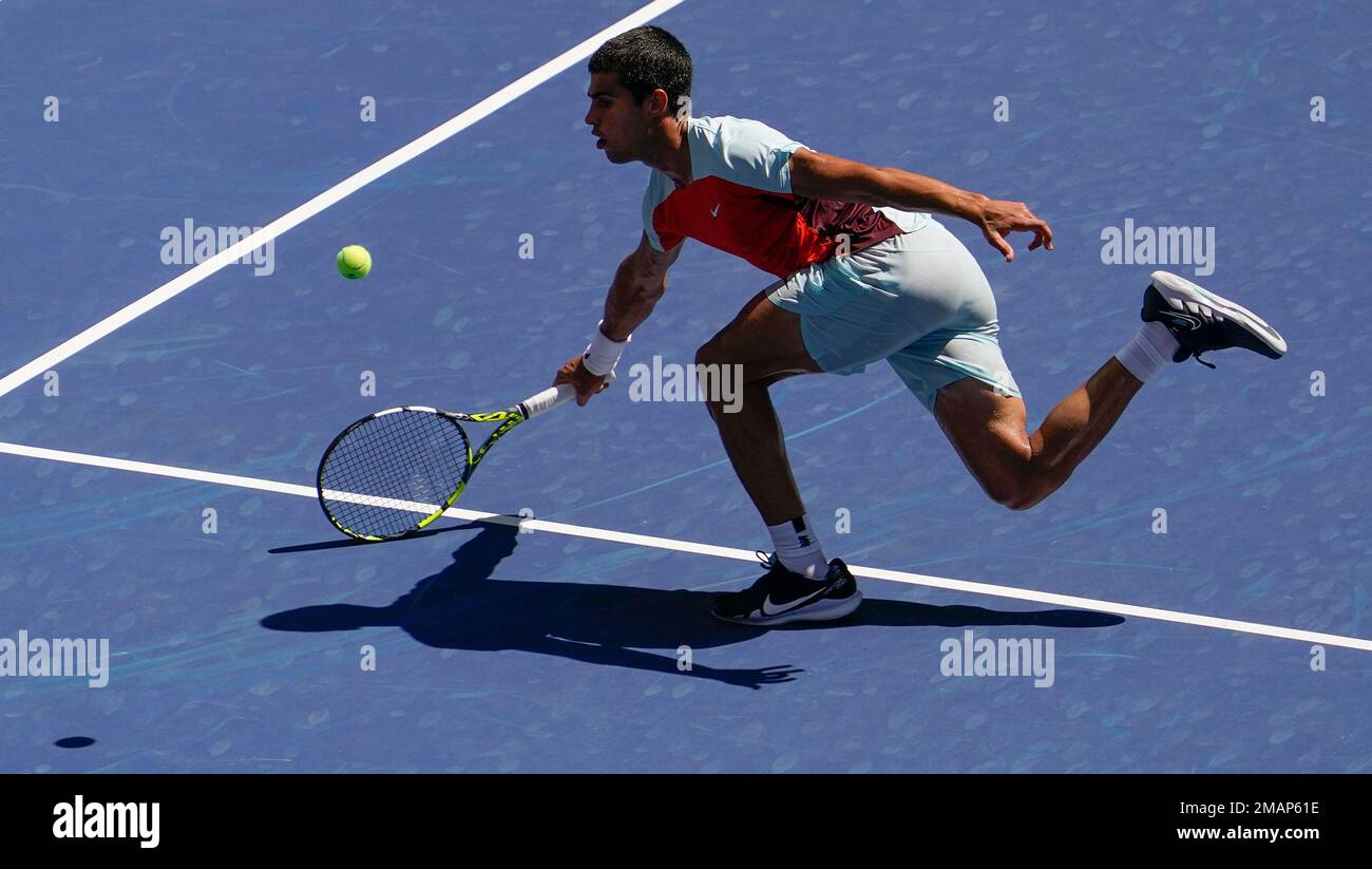 Carlos Alcaraz, of Spain, returns a shot to Sebastian Baez, of ...