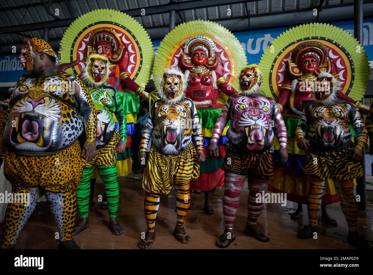 Pulikali or tiger dance artists pose for photographs before ...
