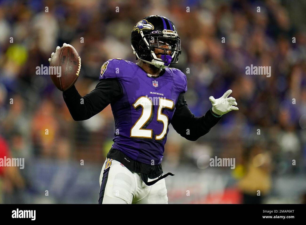 Baltimore Ravens cornerback Kevon Seymour (25) holds a football in the ...