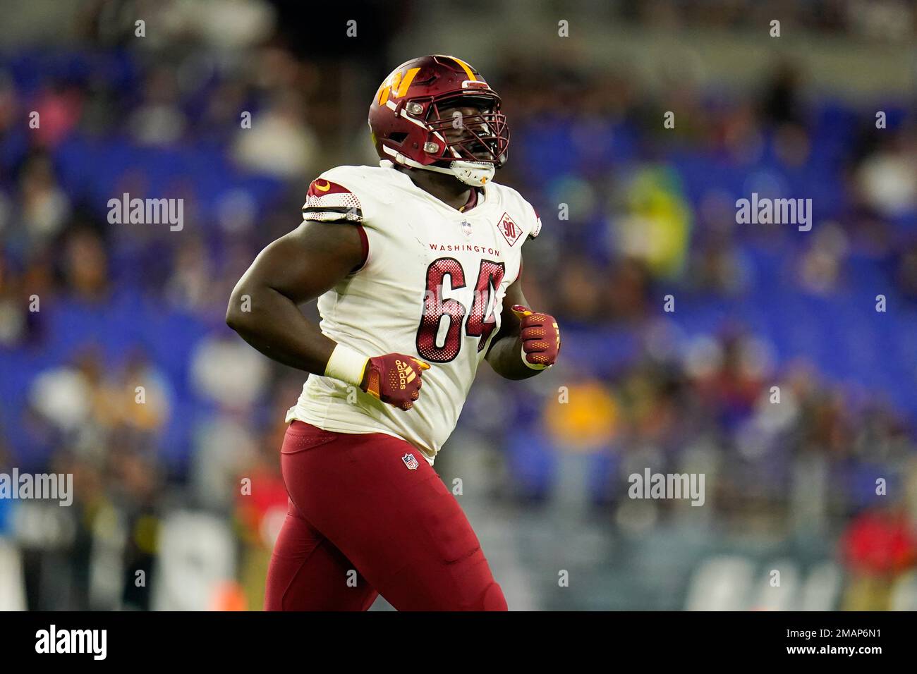 Washington Commanders guard Willie Beavers (64) runs off the field ...