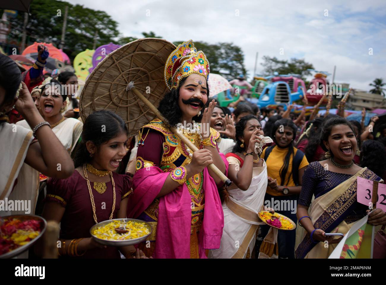 Children including one dressed like demon king Mahabali cheer as they ...