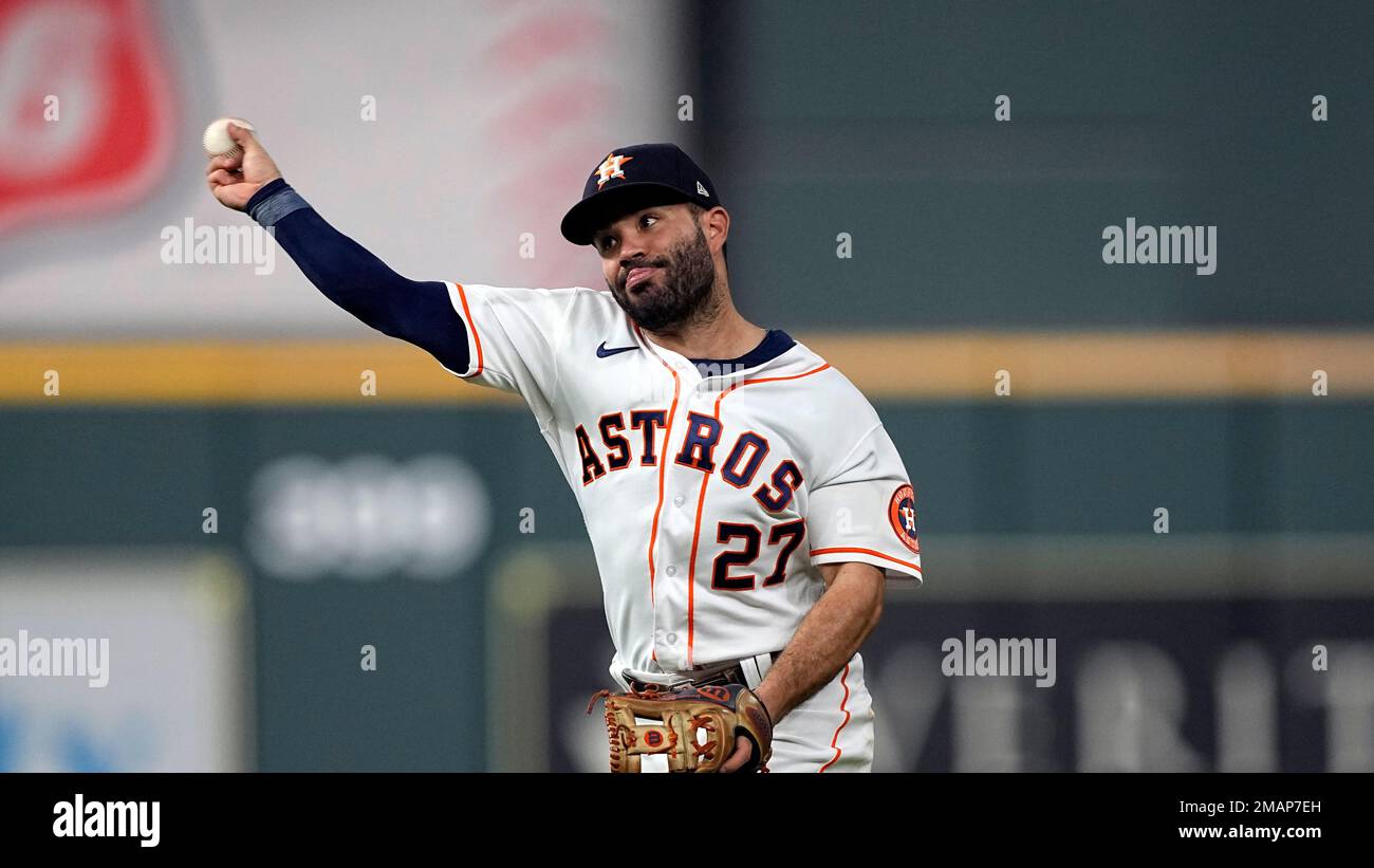 Houston Astros' Jose Altuve throws to first after fielding a ground ...